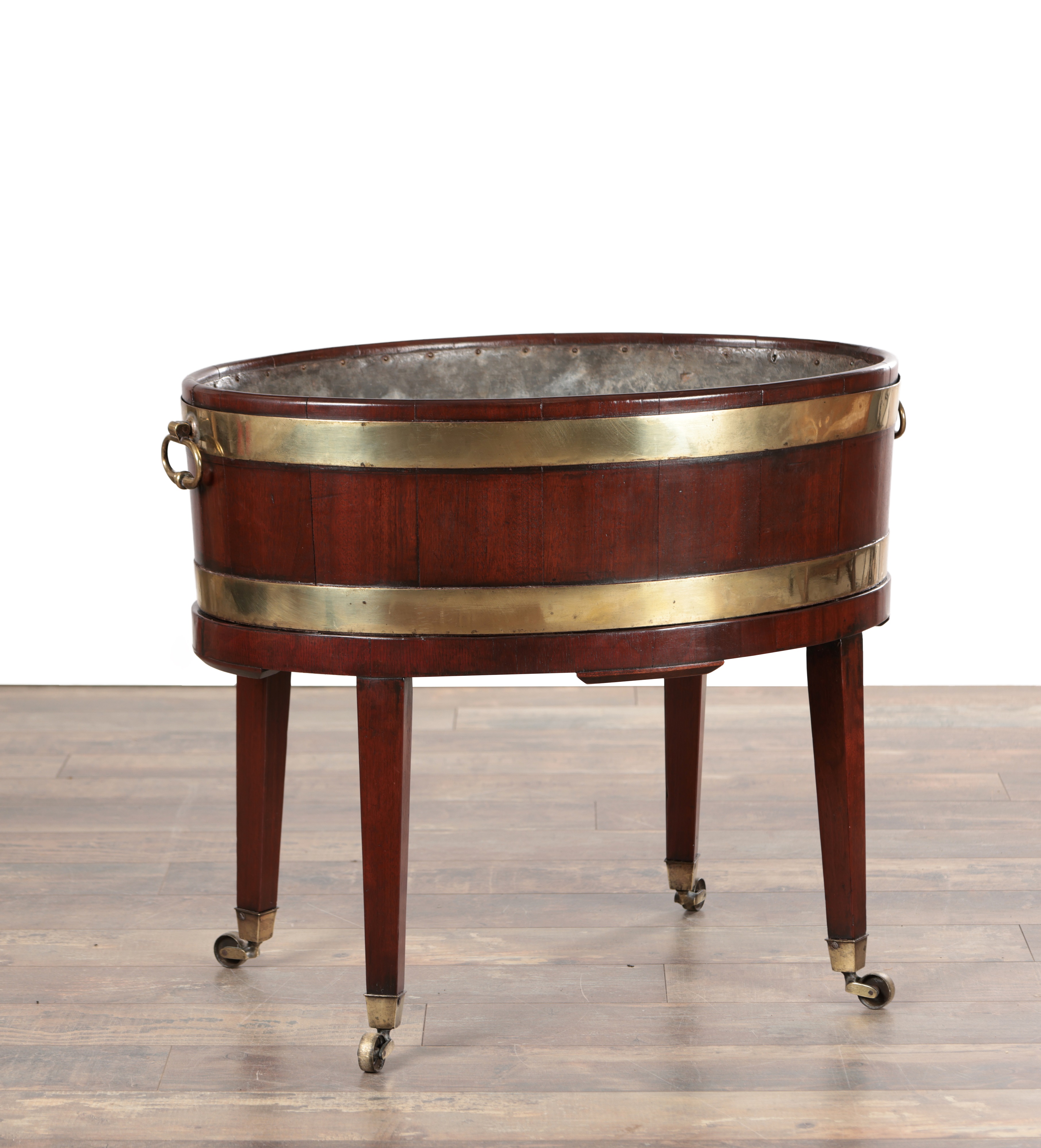 A GEORGE III MAHOGANY BRASS-BOUND WINE COOLER ON STAND